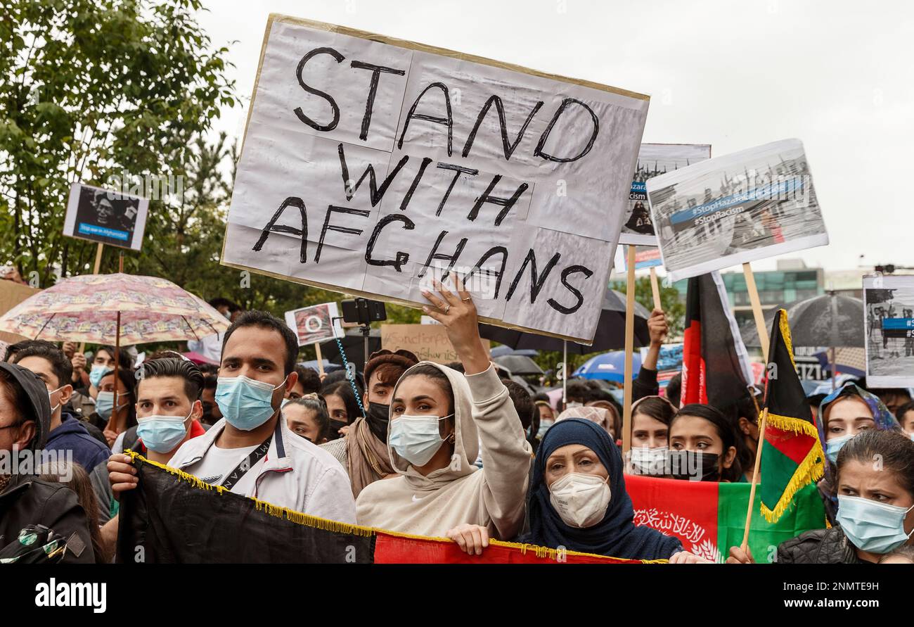 A woman holds a sign reading "Stand with Afghans" during a ...