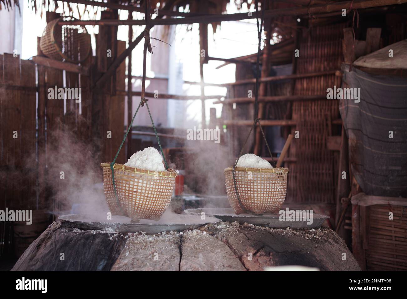 boiling saline solution in pan is traditional way for making mountain ...