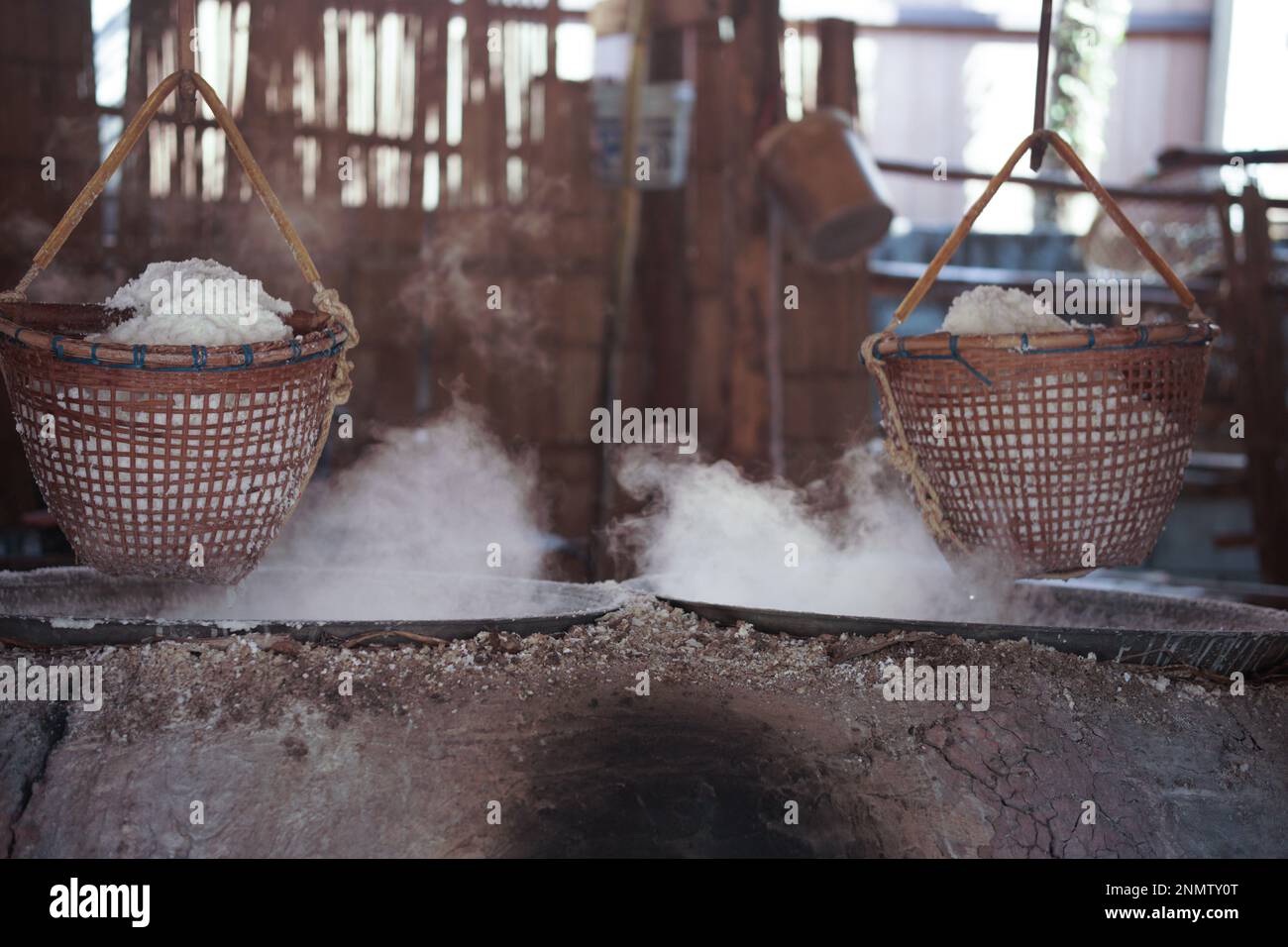 boiling saline solution in pan is traditional way for making mountain ...
