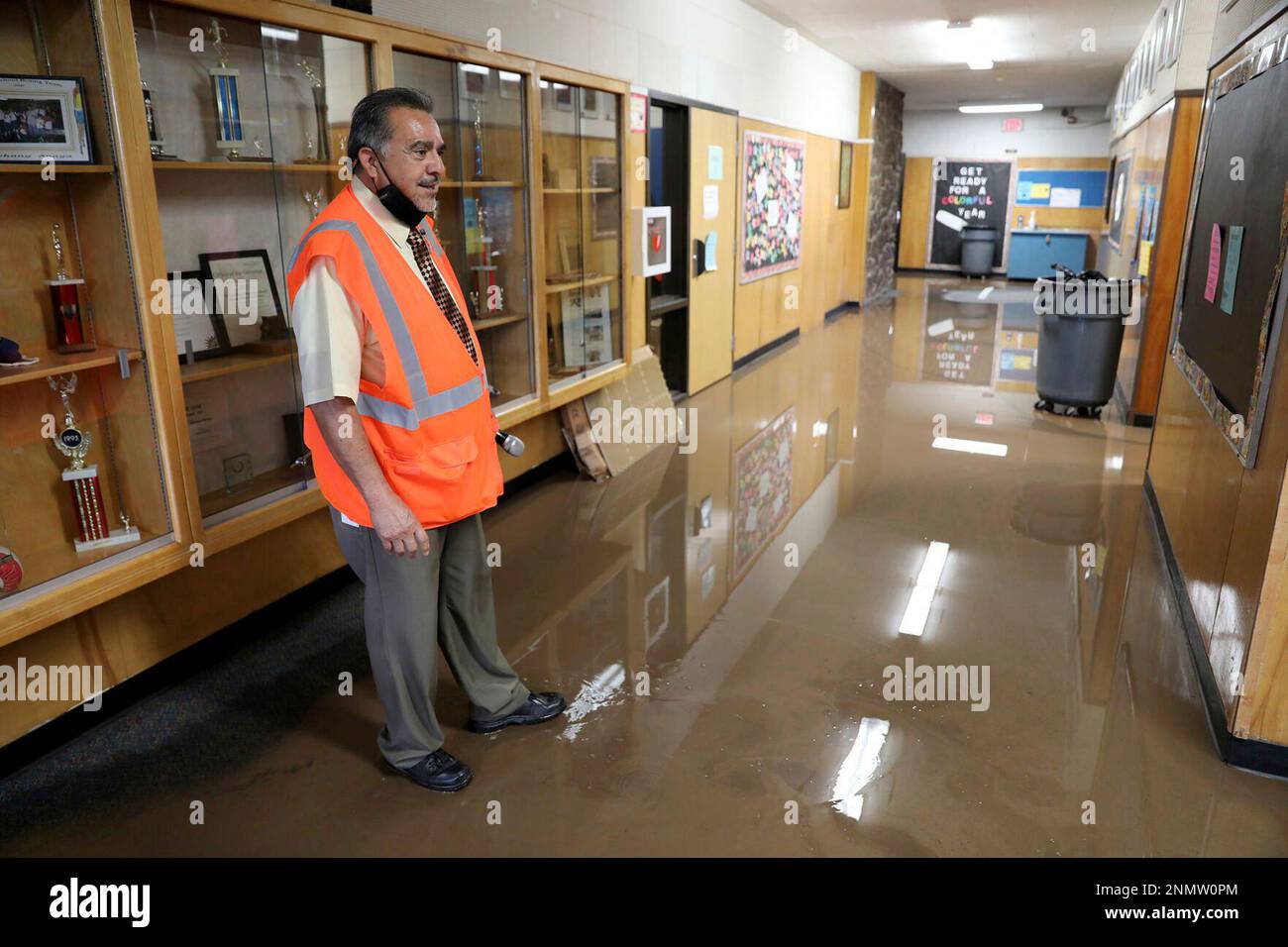 Killip Elementary School principal Joe Gutierrez looks over flooding ...