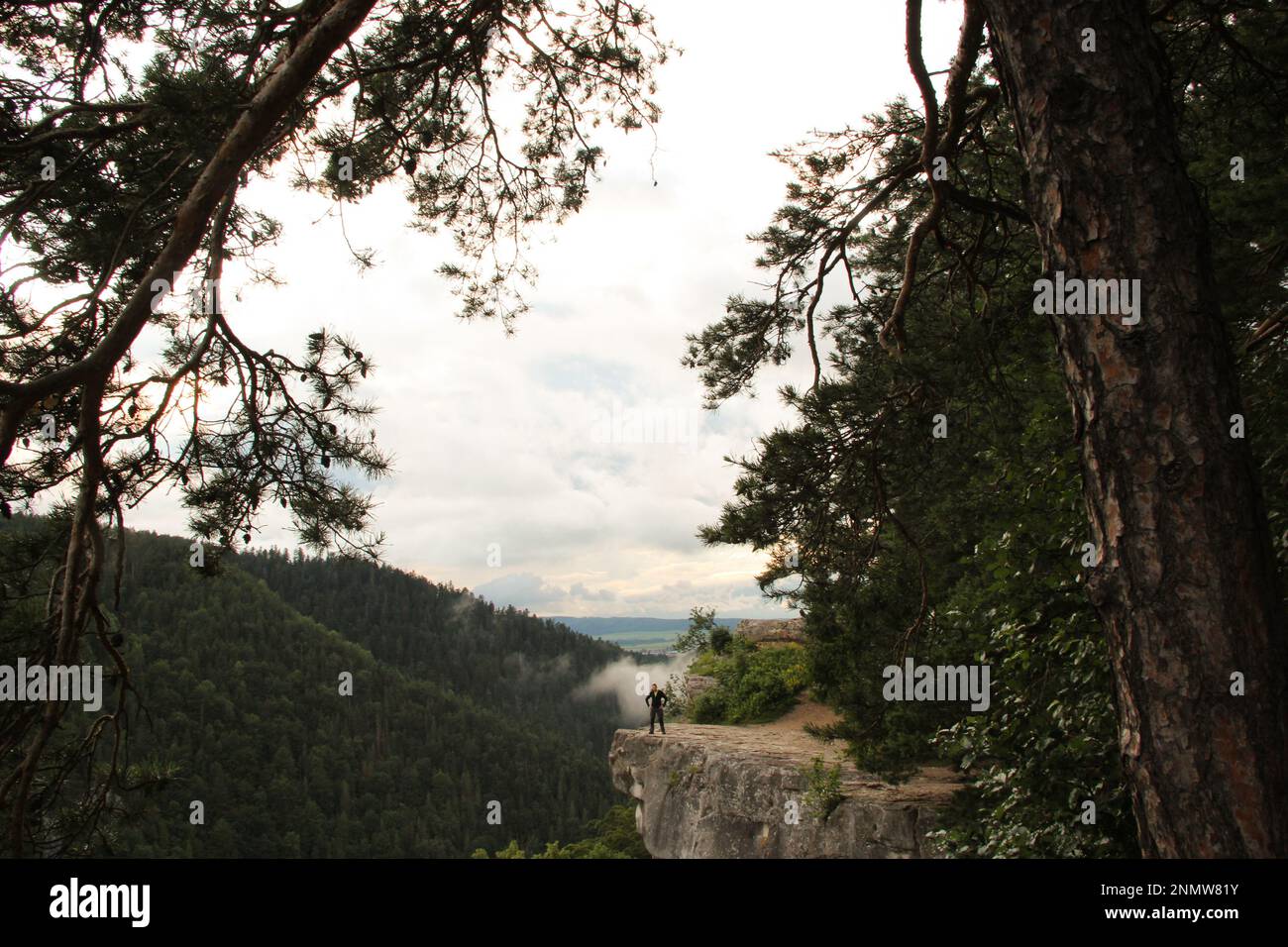 A man standing on a ledge just above the abyss. Slovakia Stock Photo ...