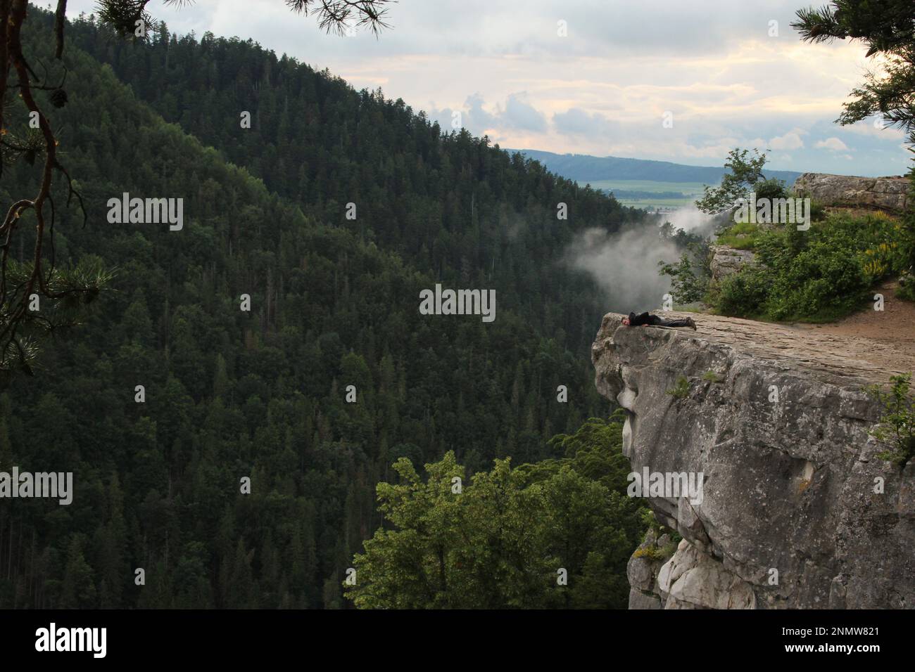 Man standing on cliff ledge hi-res stock photography and images - Alamy