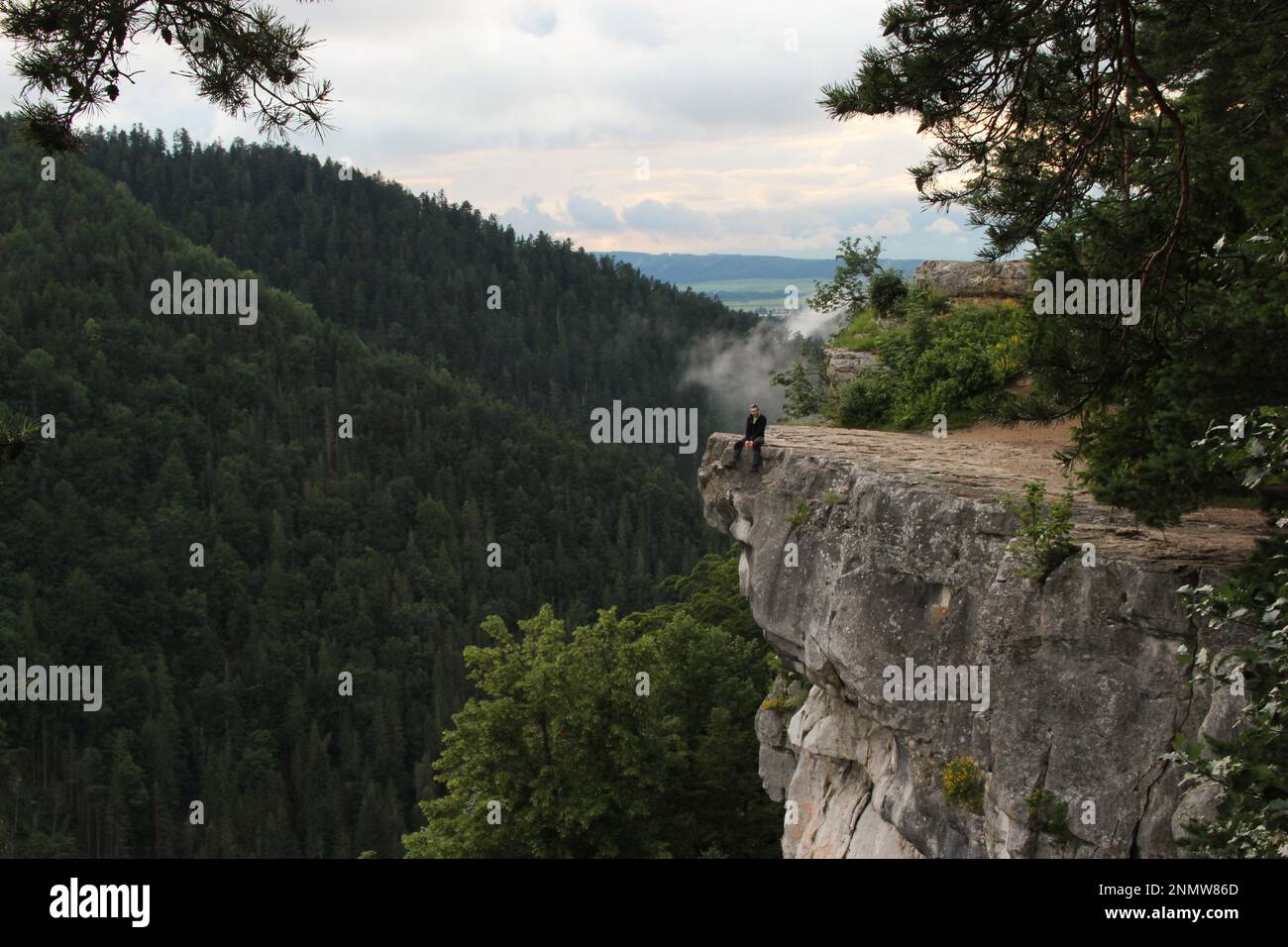 Man standing on cliff ledge hi-res stock photography and images - Alamy