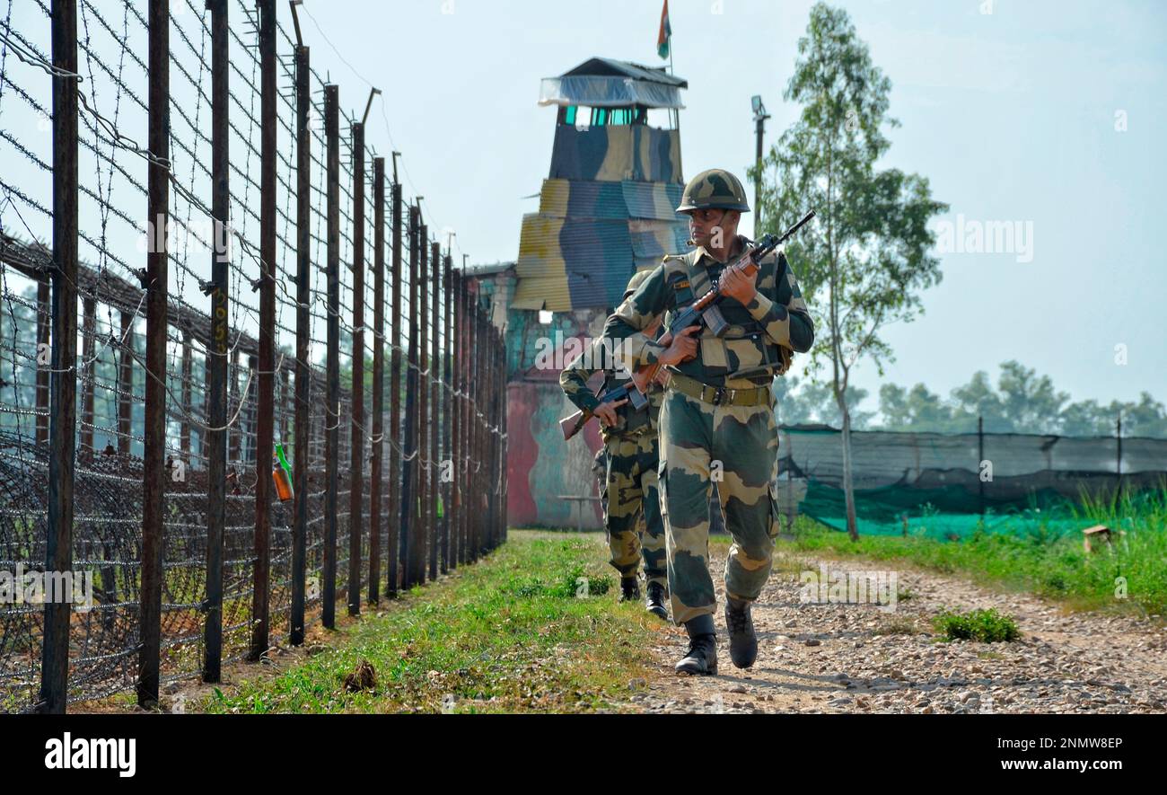 Border Security Force (BSF) personnel patrolling along the barbed wire ...