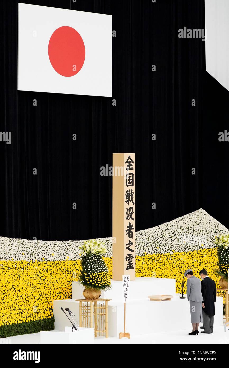 Japan's Emperor Naruhito, right, and Empress Masako observe a moment of ...