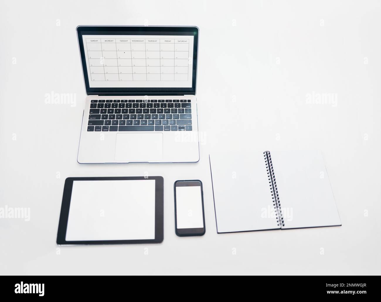 Laptop, tablet and phone mockup with notebook above for schedule ...