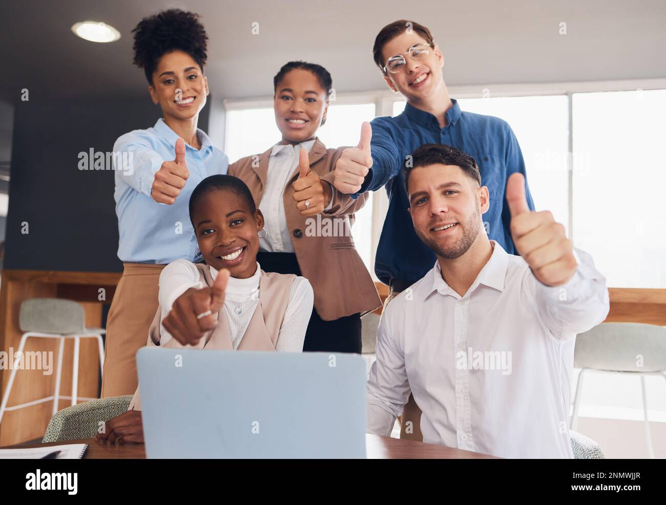 Business people, laptop and team thumbs up for success, good job or teamwork planning in meeting ...