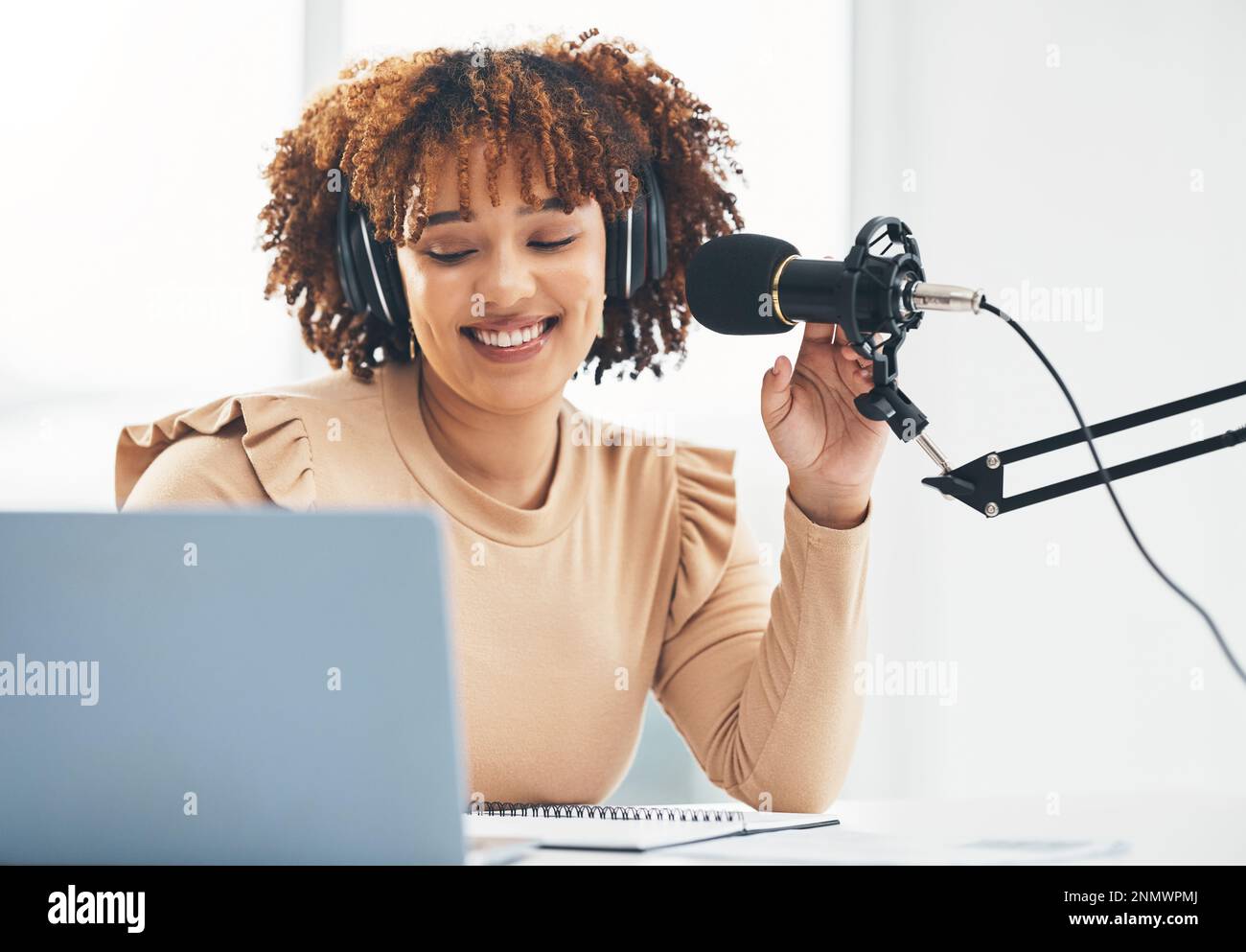 Laptop, microphone and media with a black woman presenter talking ...