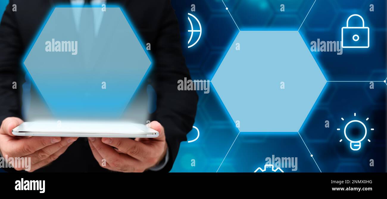 Businessman in black suit standing and holding tablet in two hands ...