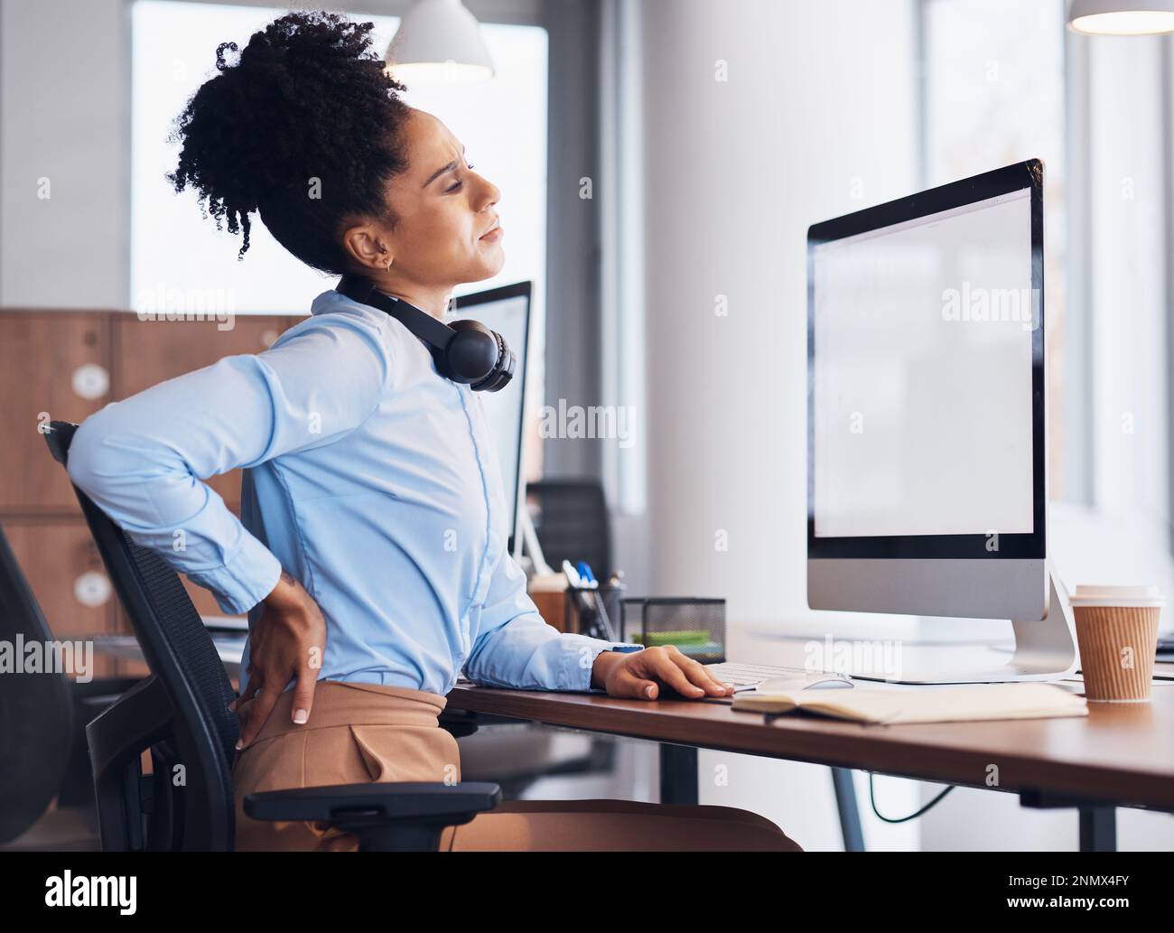 Back pain, call center and business black woman with injury, muscle ...