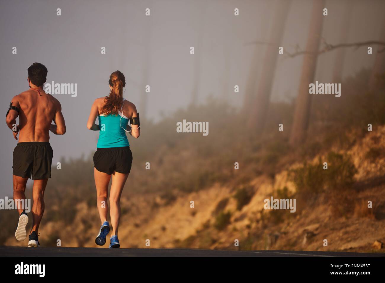 Running through life together. an athletic young couple out for a run ...