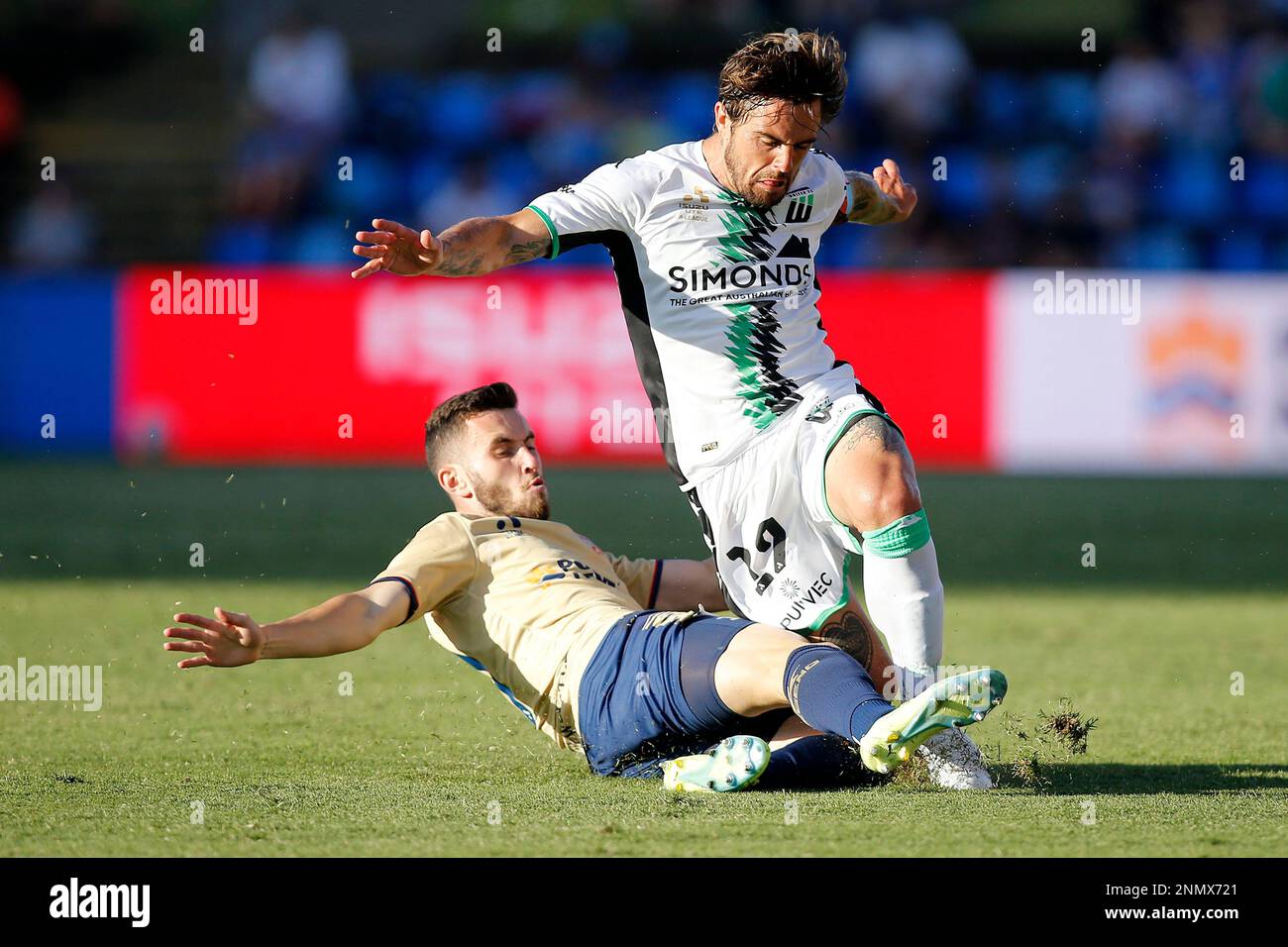 Thomas Aquilina of the Jets tackles Josh Risdon of Western United ...