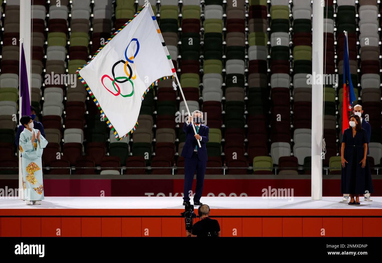 Paris Mayor Anne Hidalgo (R) prepares to receive the Olympic flag from ...