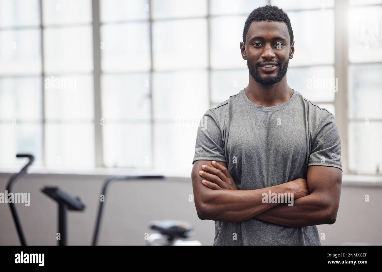 Happy black man smile in gym with arms crossed for training, exercise or workout in Nigeria ...
