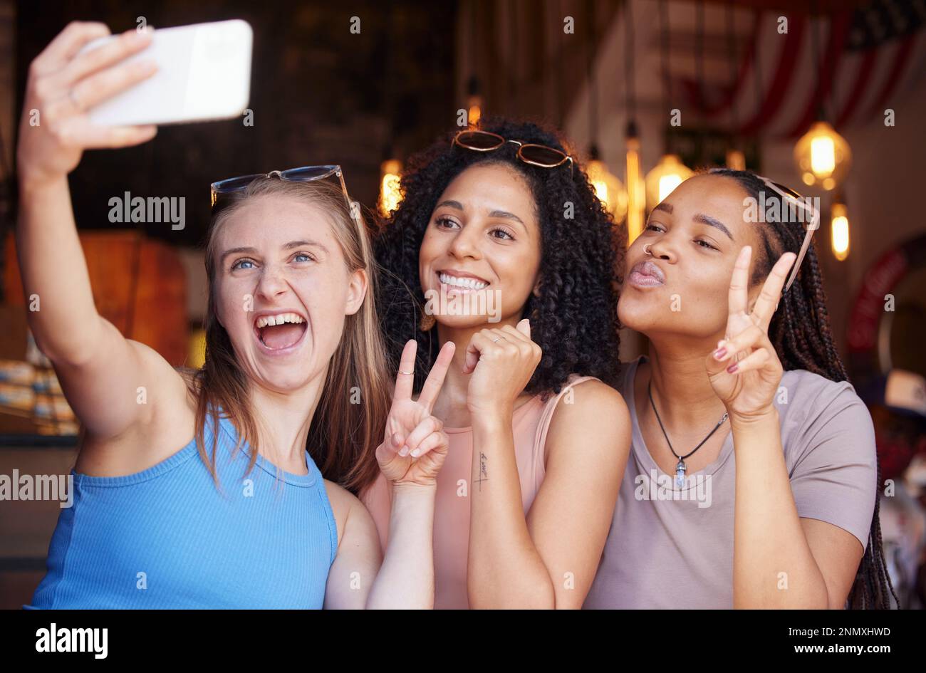 Peace sign, friends and selfie with women in restaurant for social ...