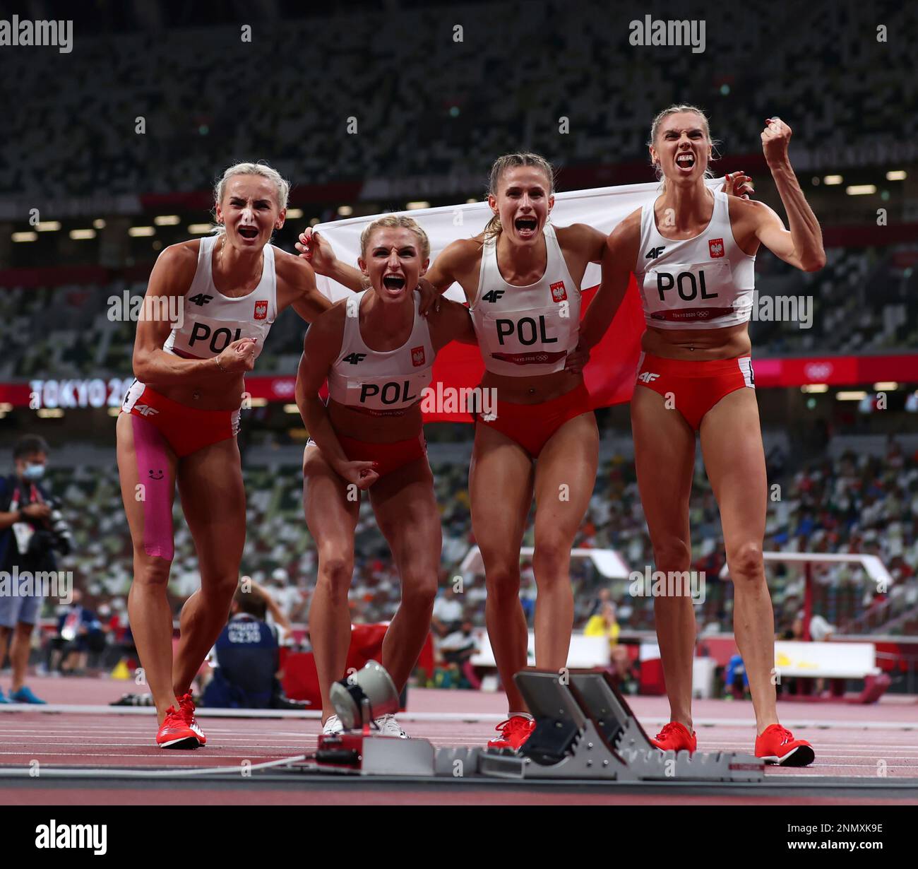 Members of Poland celebrate after winning Athletics women's 4x400m ...