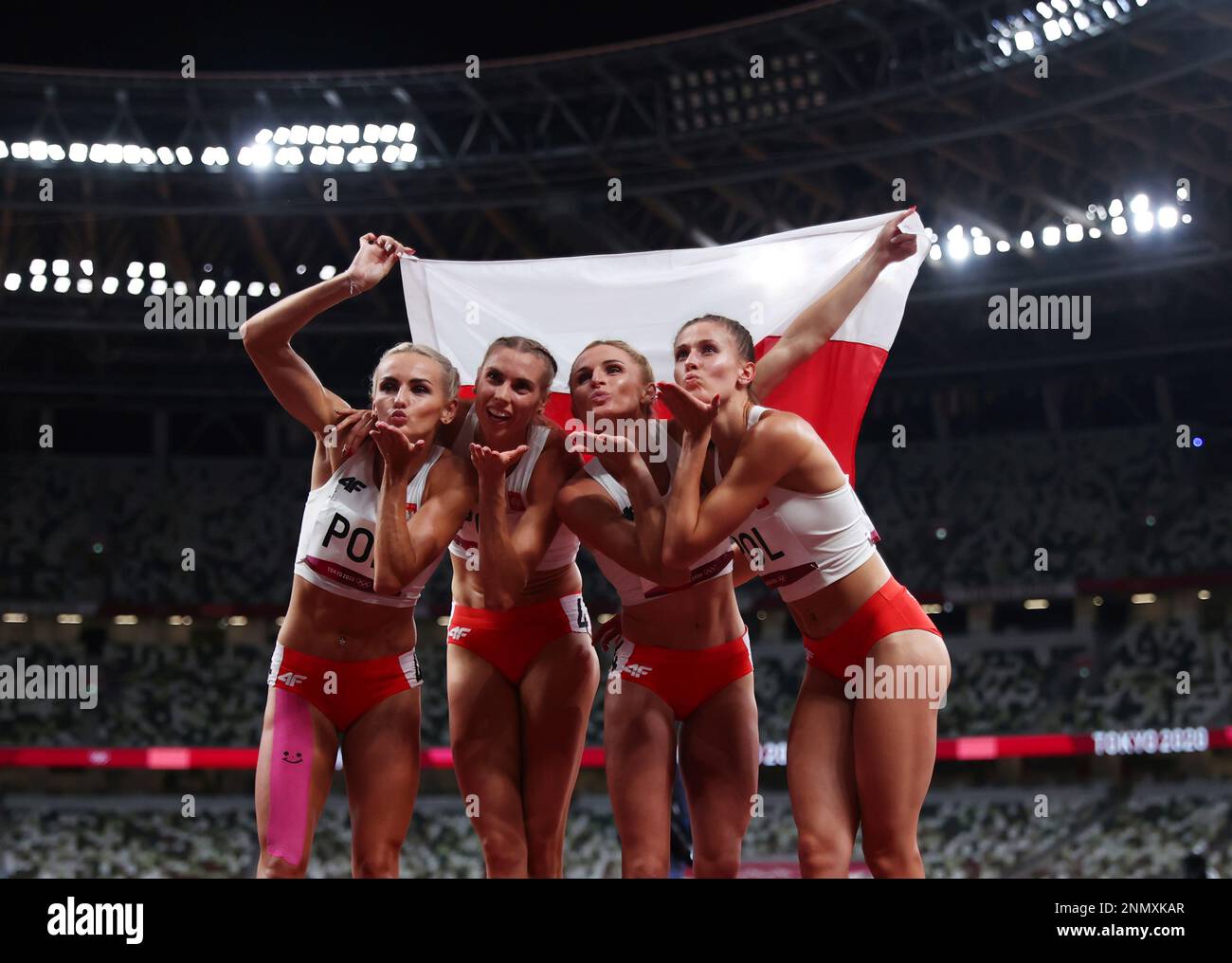 Members of Poland celebrate after winning Athletics women's 4x400m ...