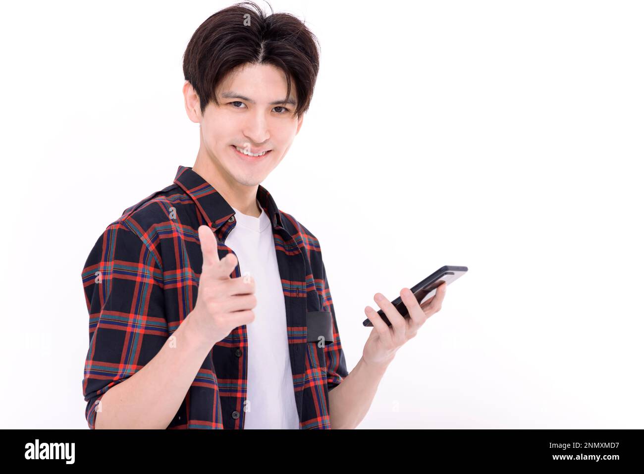 Happy young man holding cell phone isolated on white background Stock ...