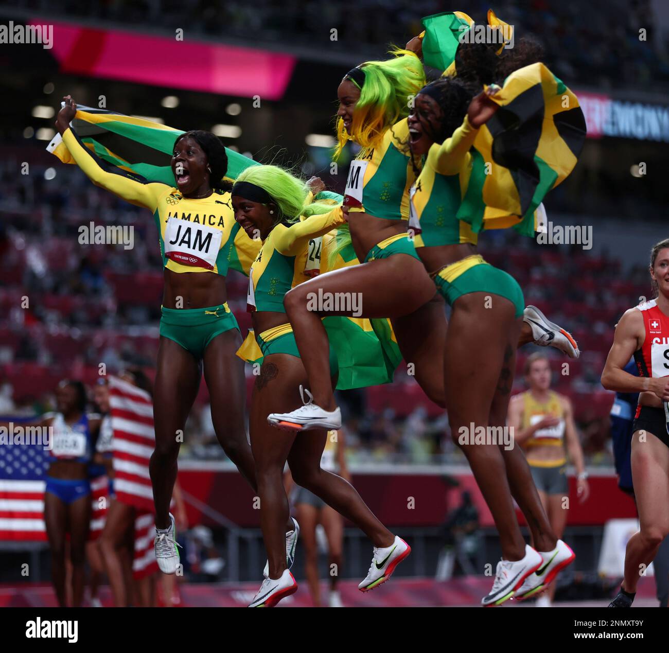 Jamaica's team memebers jump for joy after capturing the gold medal of the Women's ' 4 x100 ...