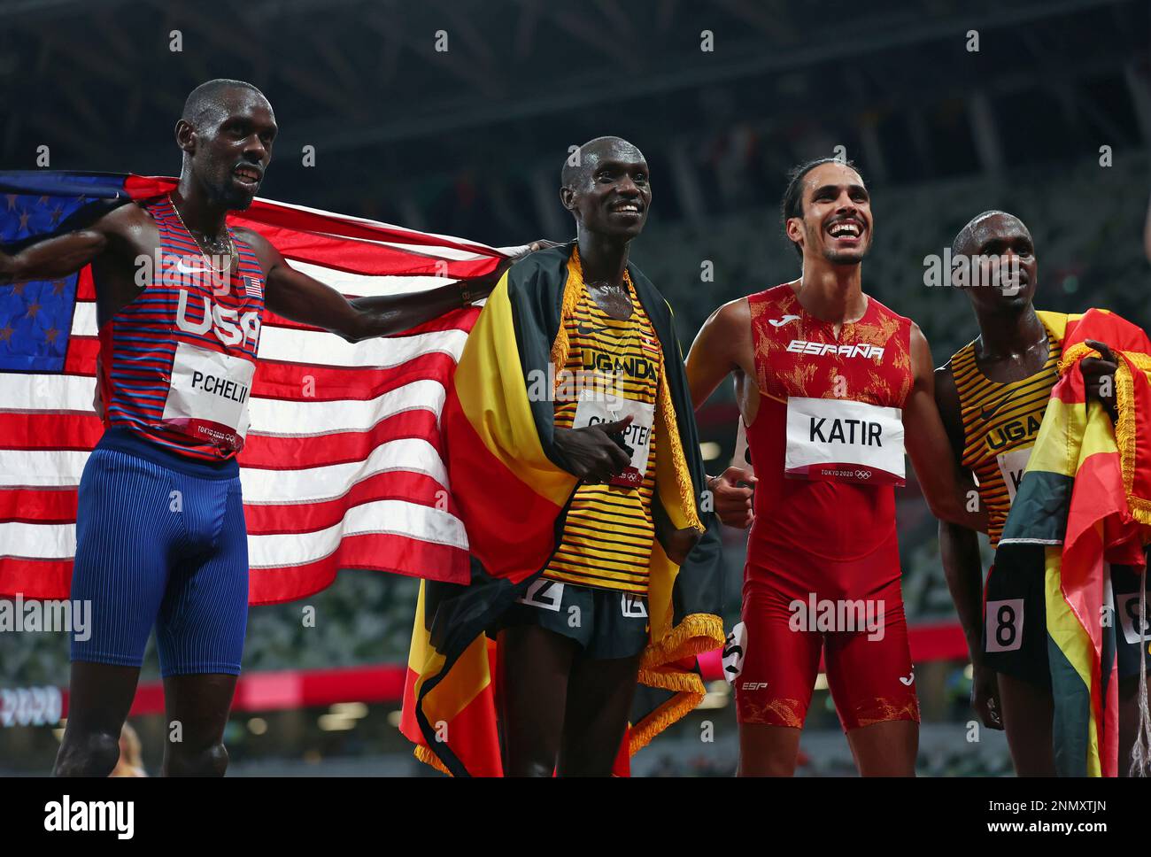 Uganda's CHEPTEGEI Joshua (2nd from L) celebrates with USA's CHELIMO ...