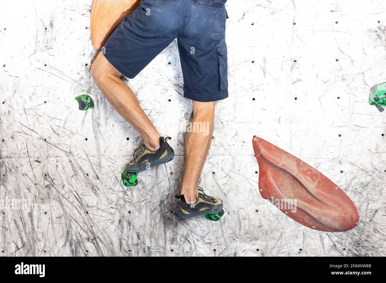 Close up view of young man or climber feet in climbing shoes on ...