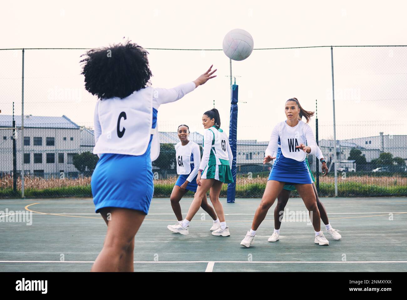 Fitness, sports and netball match by women at outdoor court for ...