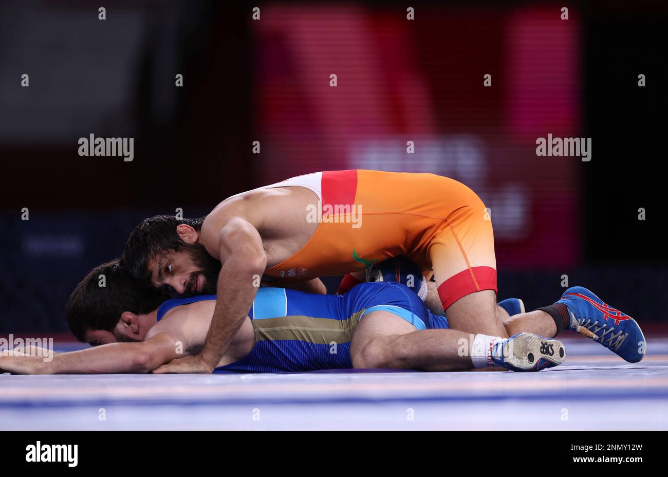 India's RAVI Kumar (red) and ROC's UGUEV Zavur compete during Wrestling ...