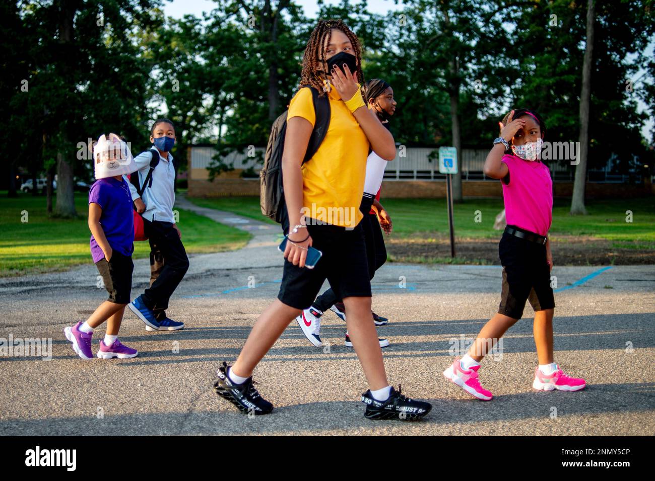 Sixth-grader Taulaya Humphrey, center, walks into school with other students during the first ...