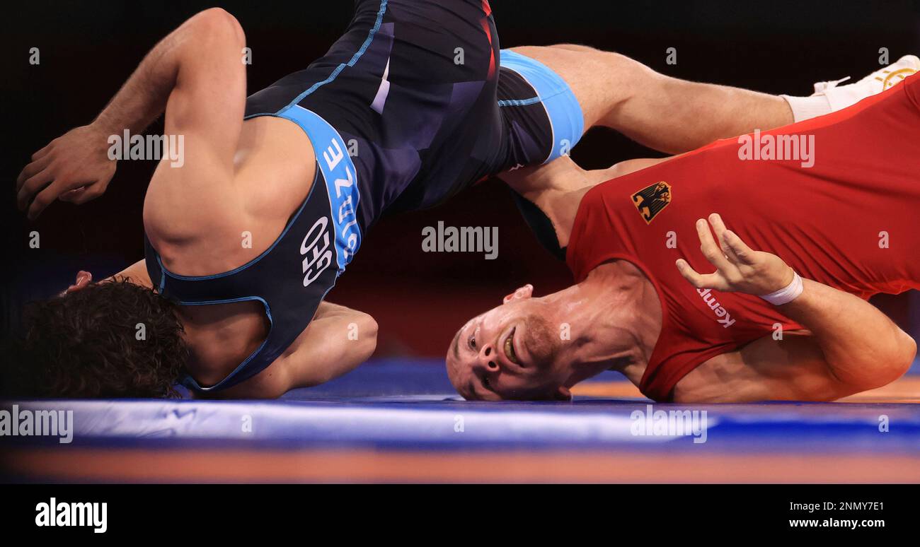STAEBLER Frank (R, red) of Germany throws ZOIDZE Ramaz of Georgia ...