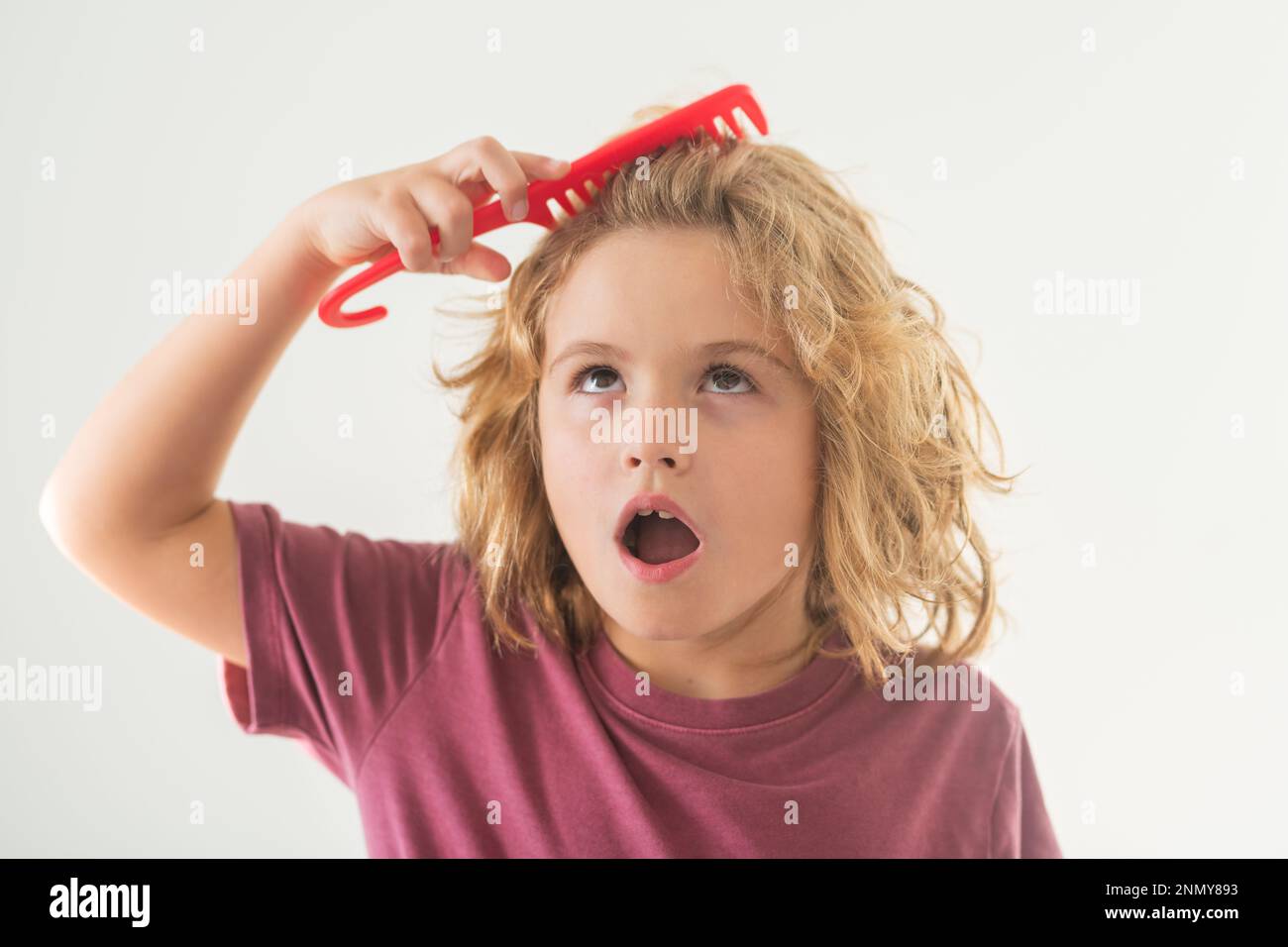 Funny hairstyle. Kid boy makes face expressions, combing hair. Cute ...