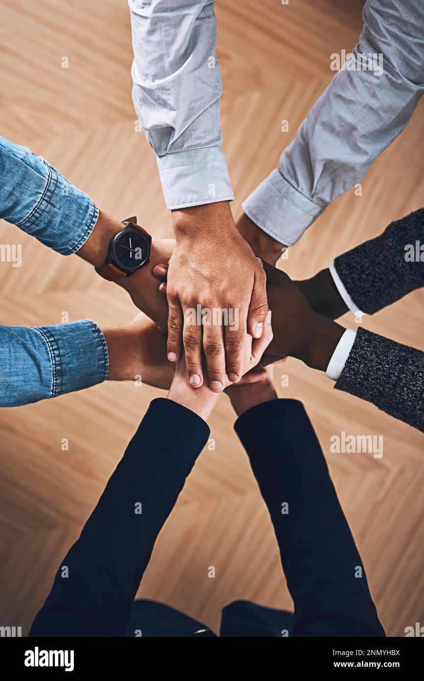 Working hard to achieve team success. High angle shot of a group of ...