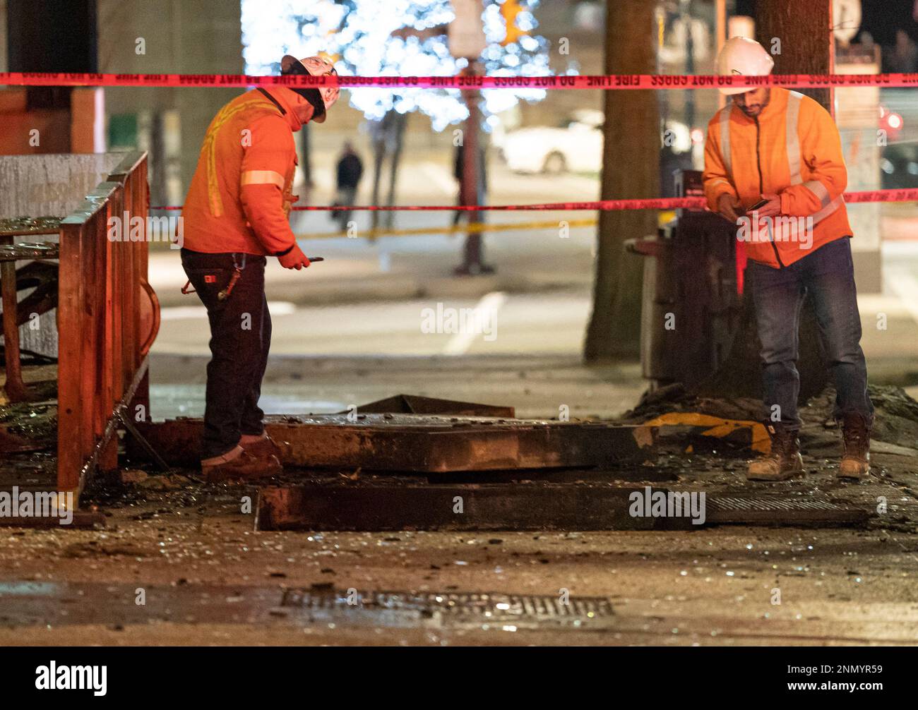 Canada. 24th Feb, 2023. Officials take pictures while looking into an ...