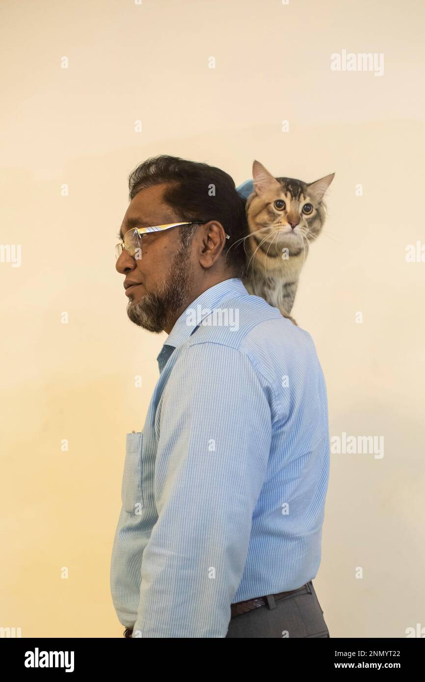 Dhaka, Bangladesh. 24th Feb, 2023. A cat owner shows off his pet cat ...
