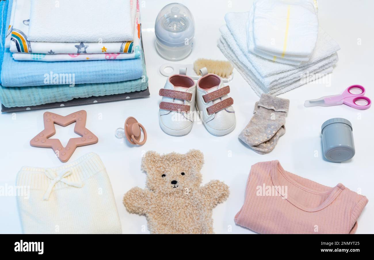 Concept of giving birth. Set of clothes and accessories for newborn on ...