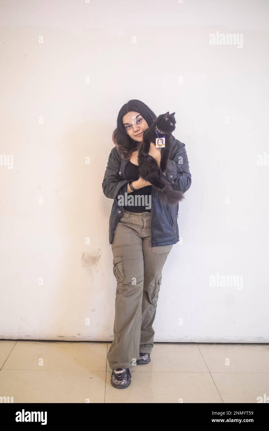 Dhaka, Bangladesh. 24th Feb, 2023. A cat owner shows off her pet cat ...