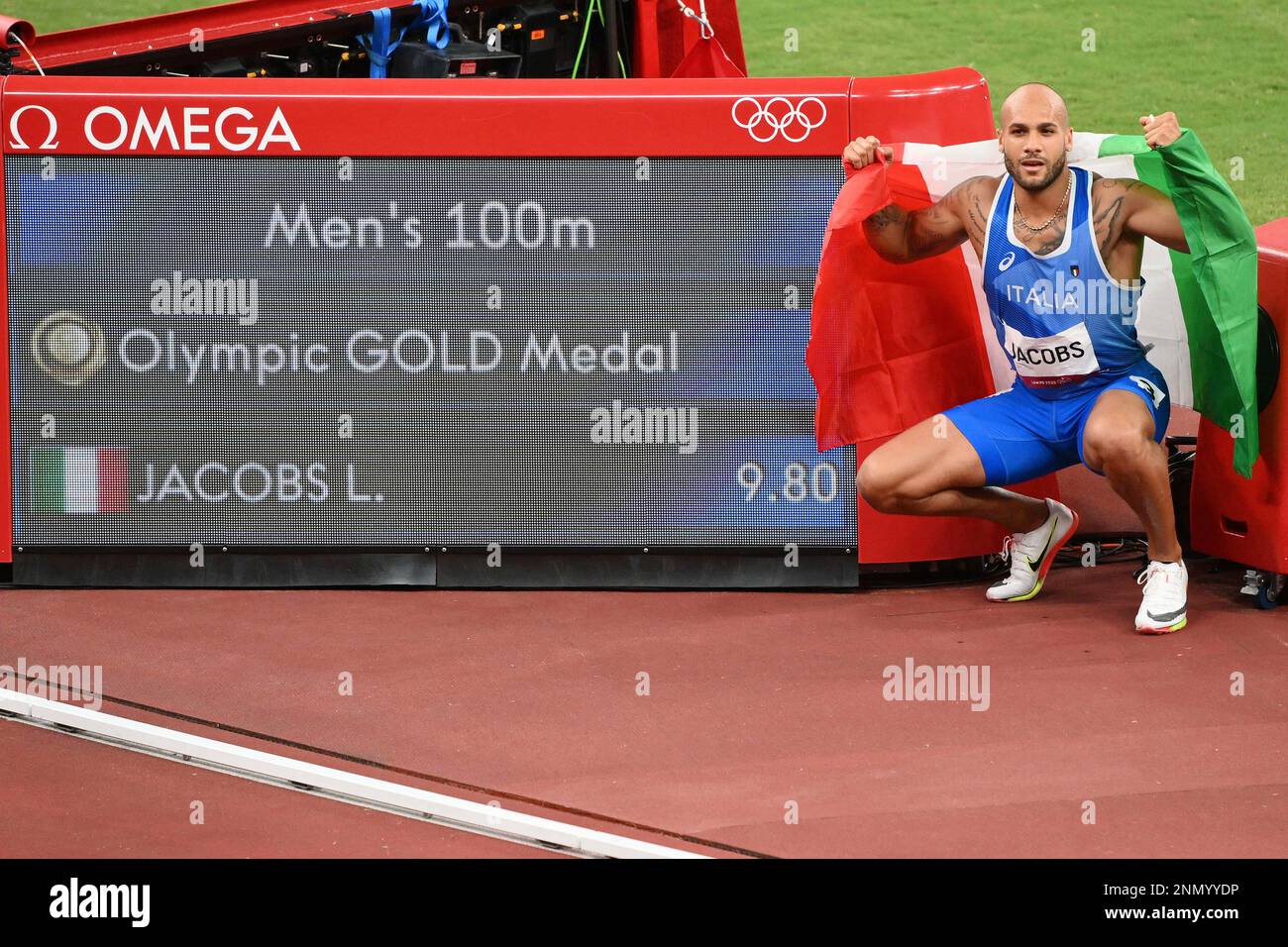 Lamont Marcell Jacobs, of Italy, poses next to the scoreboard after ...