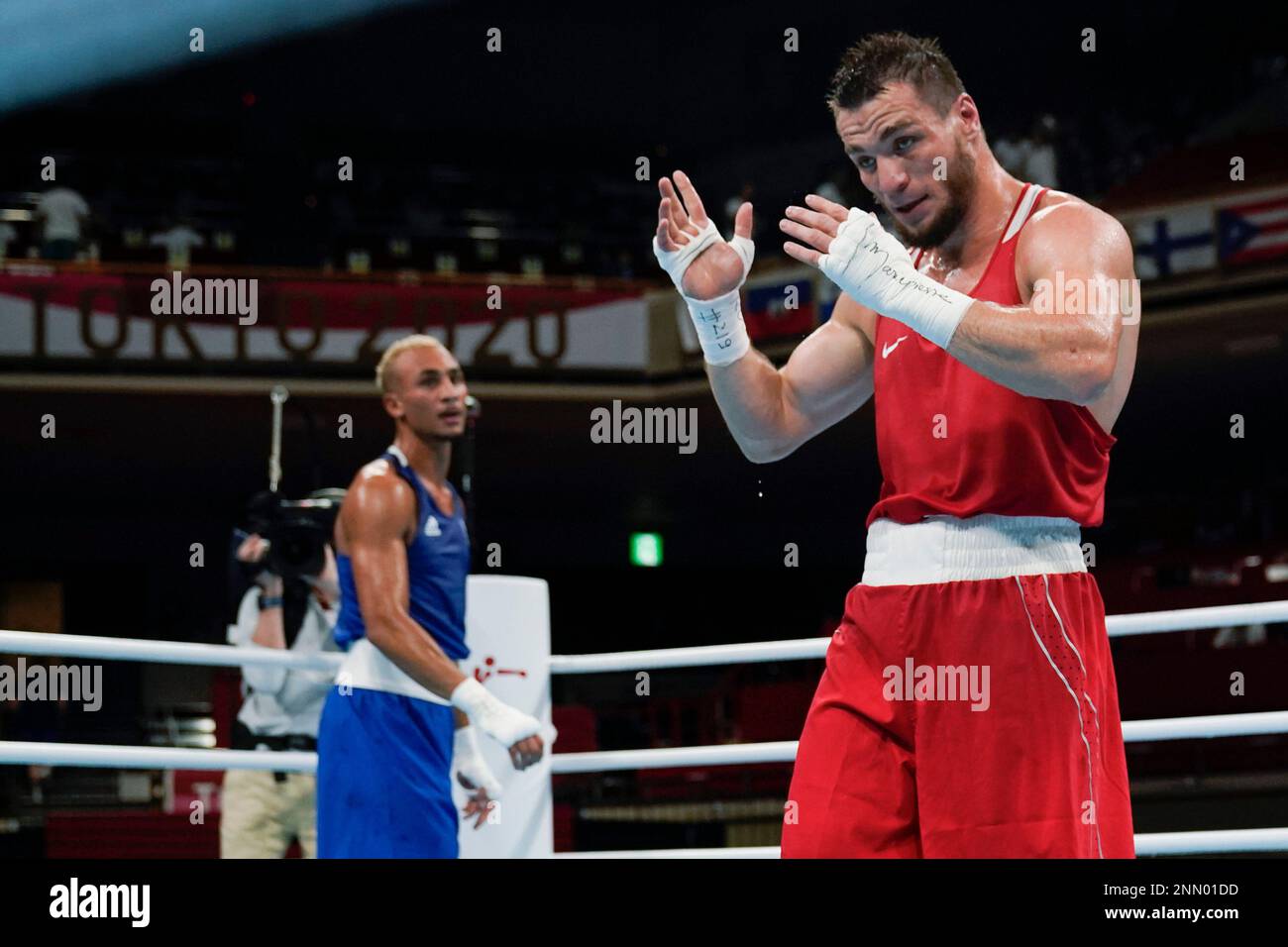 Russian Olympic Committee's Imam Khataev, right, reacts after losing a ...