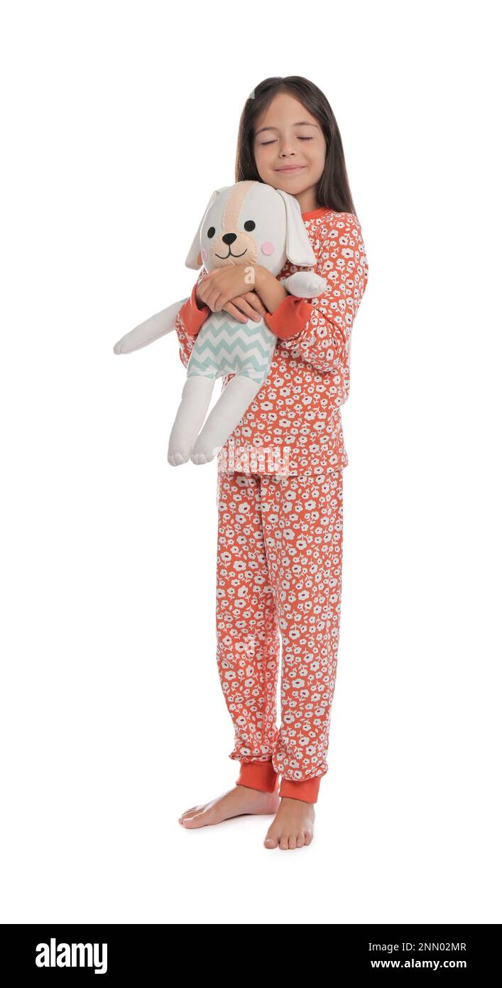 Cute girl wearing pajamas with toy on white background Stock Photo - Alamy