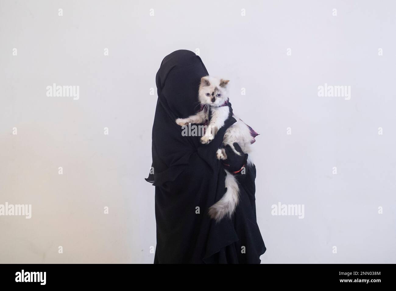 A cat owner shows off her pet cat during the cat ramp show at Jamuna ...