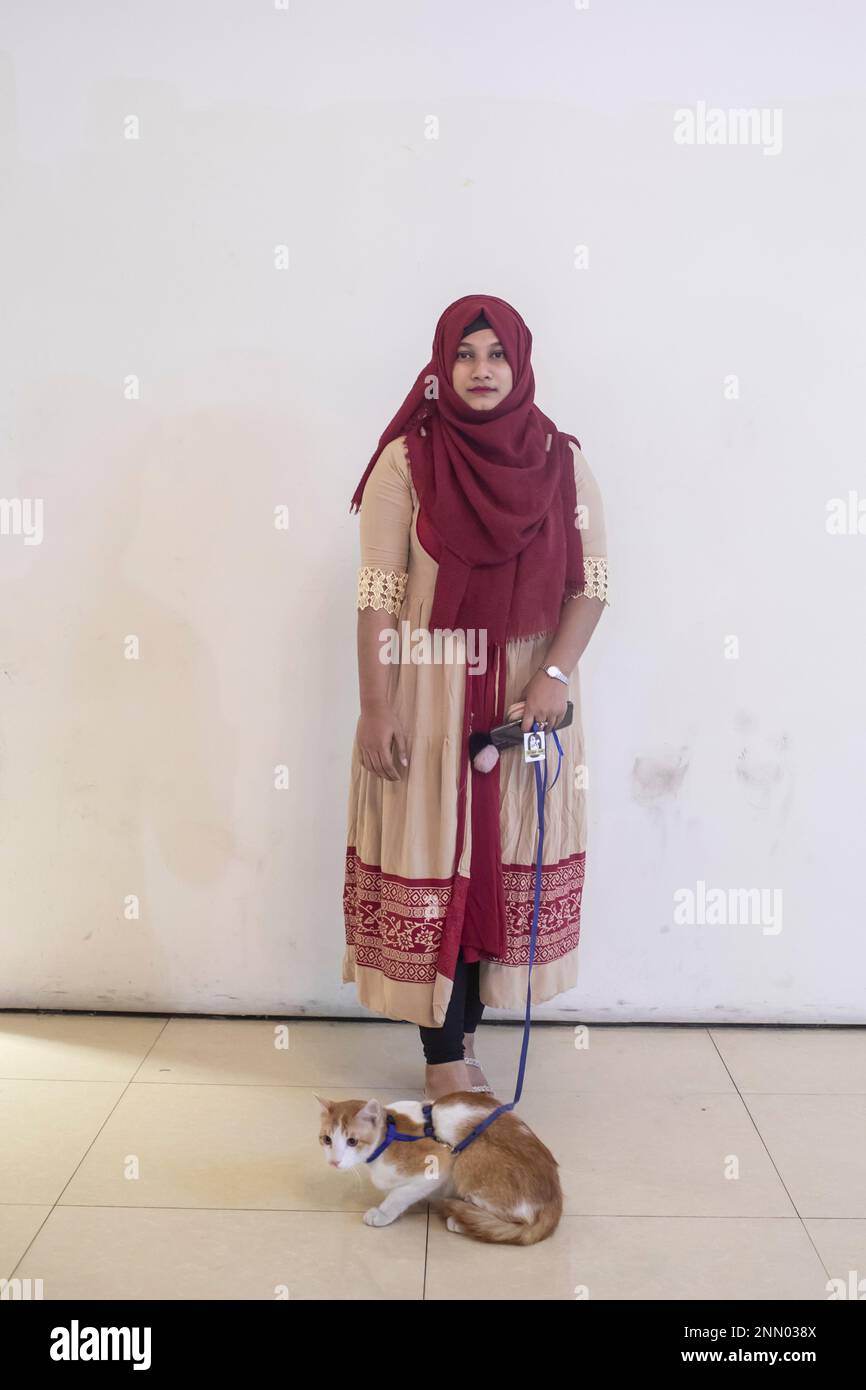 A cat owner shows off her pet cat during the cat ramp show at Jamuna ...