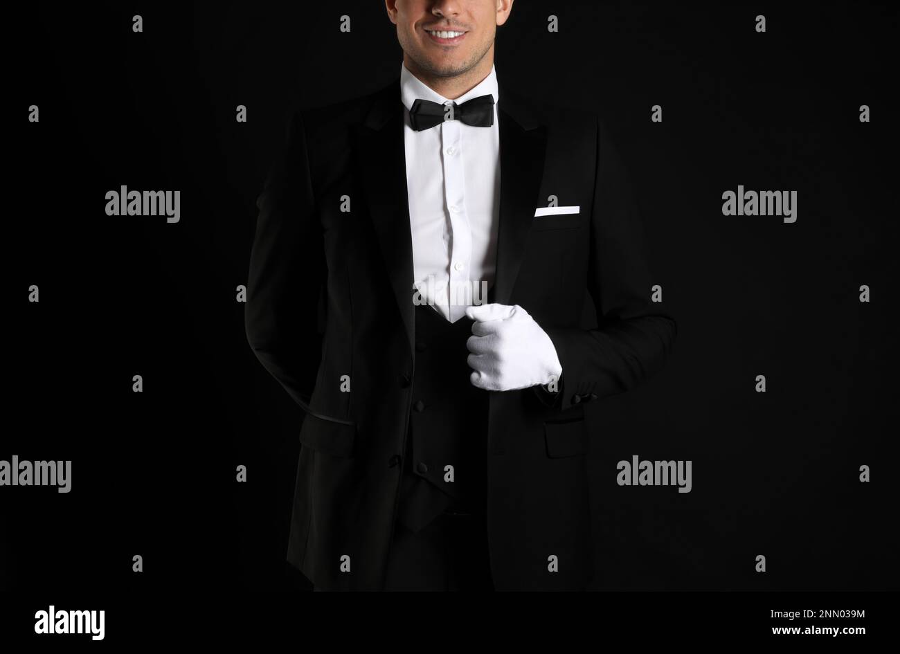 Butler in elegant uniform on black background, closeup Stock Photo - Alamy