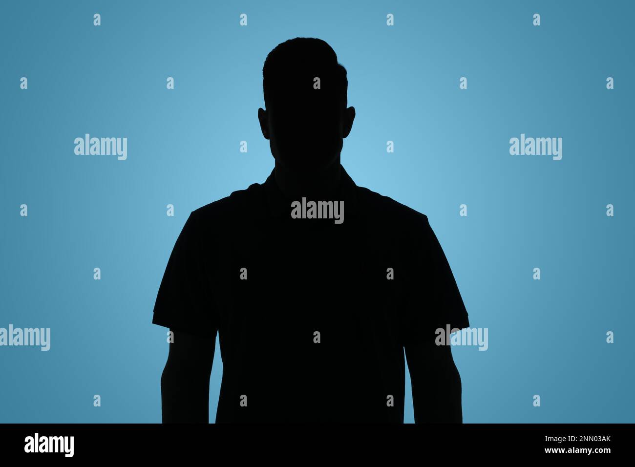 Silhouette of anonymous man on light blue background Stock Photo - Alamy