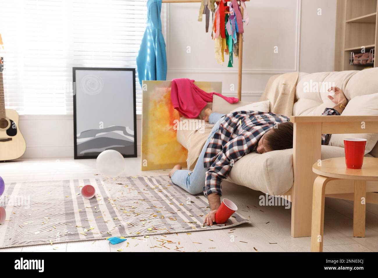 Young man sleeping on sofa in messy room after party Stock Photo - Alamy