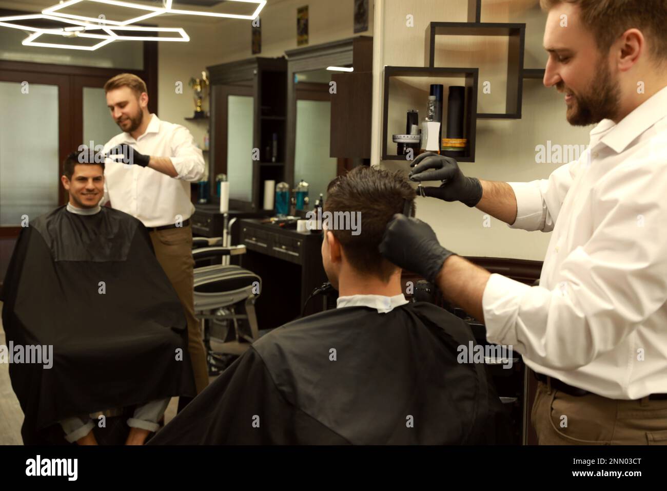 Professional hairdresser making stylish haircut in salon Stock Photo ...
