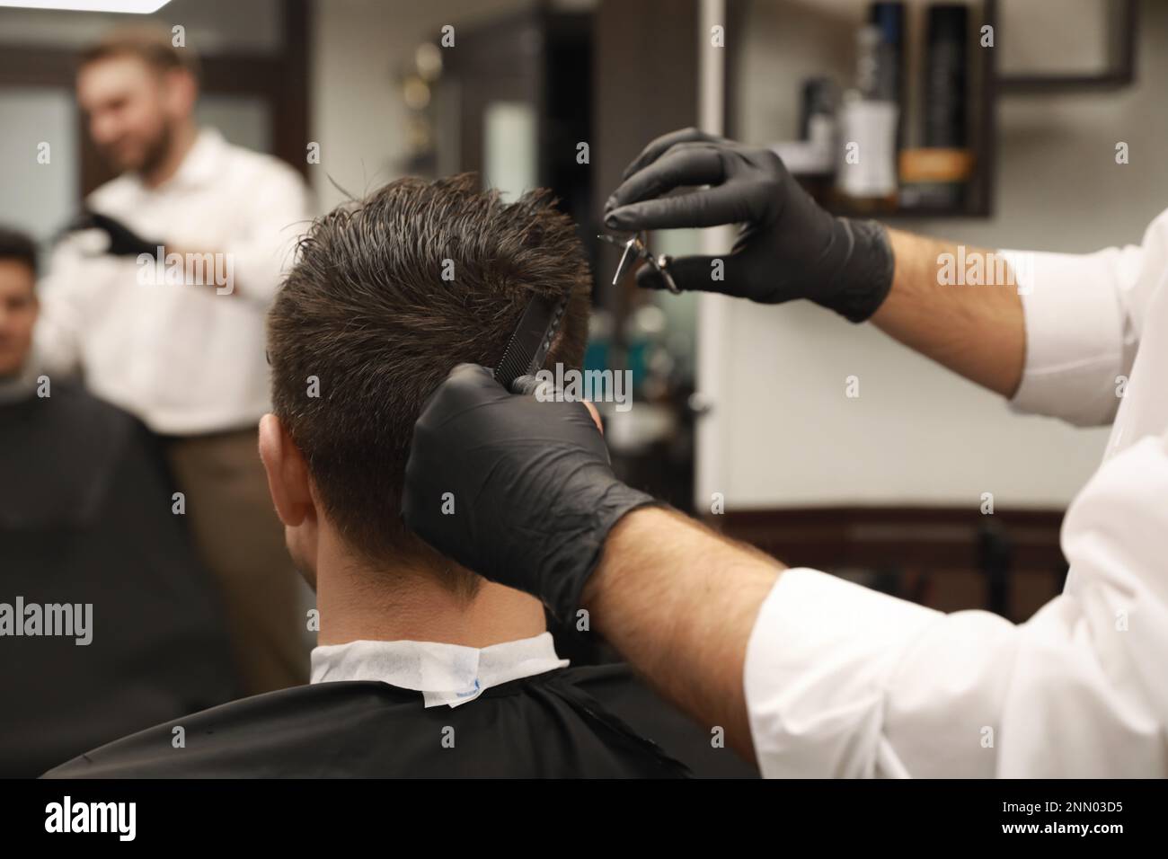 Professional hairdresser making stylish haircut in salon, closeup Stock ...