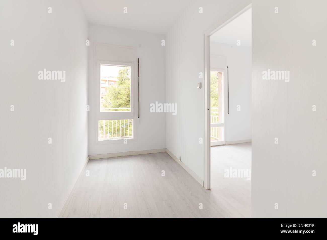 View of an empty white bright room with window without furniture after ...