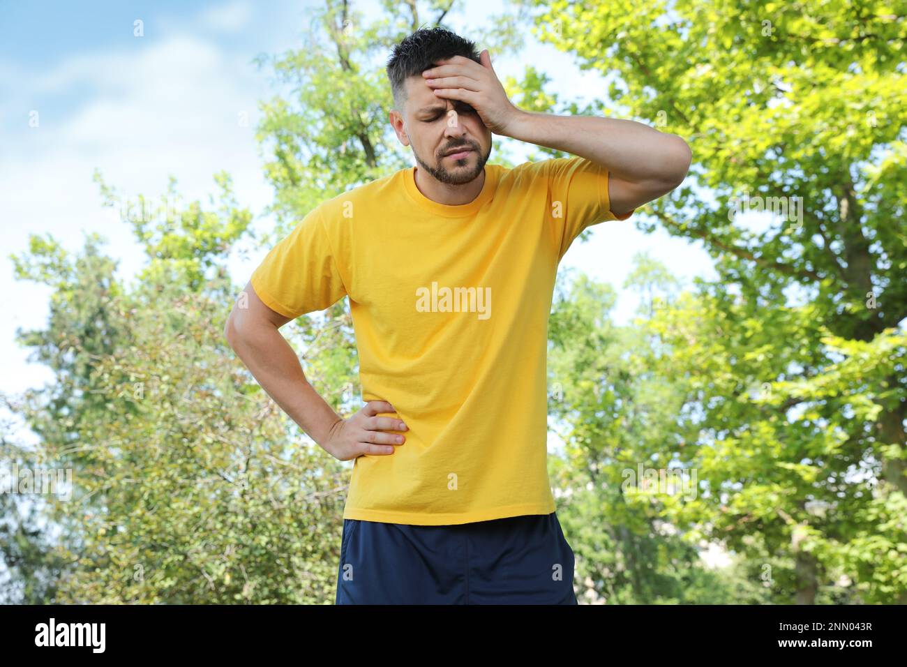 Man suffering from heat stroke in park Stock Photo - Alamy