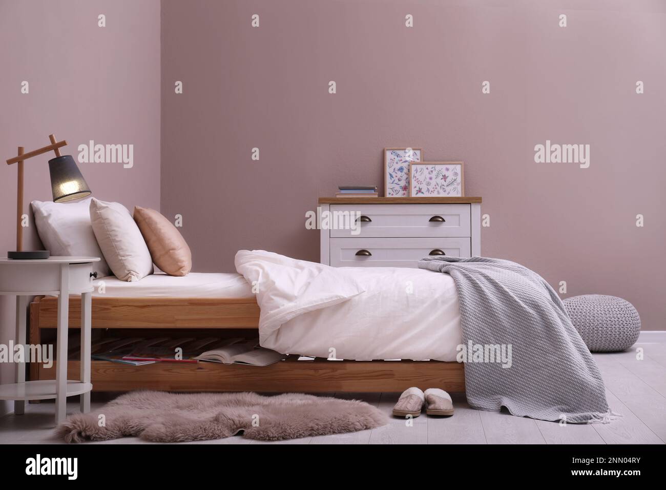 Cozy bed with soft linens in light room Stock Photo - Alamy