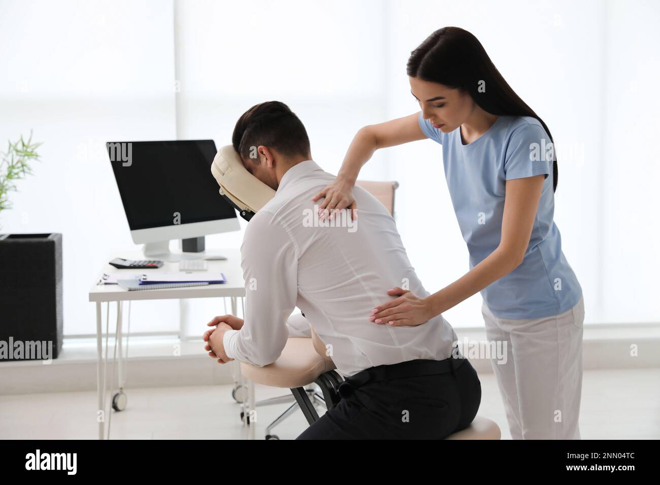 Man receiving massage in modern chair indoors Stock Photo - Alamy