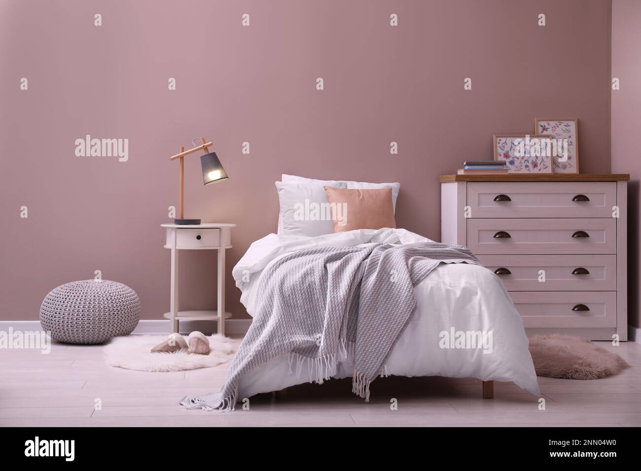 Cozy bed with soft linens in light room Stock Photo - Alamy